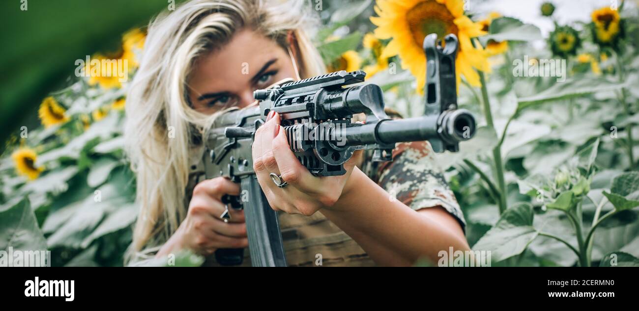 Beautiful and attractive woman soldier with rifle machine gun. Front ...