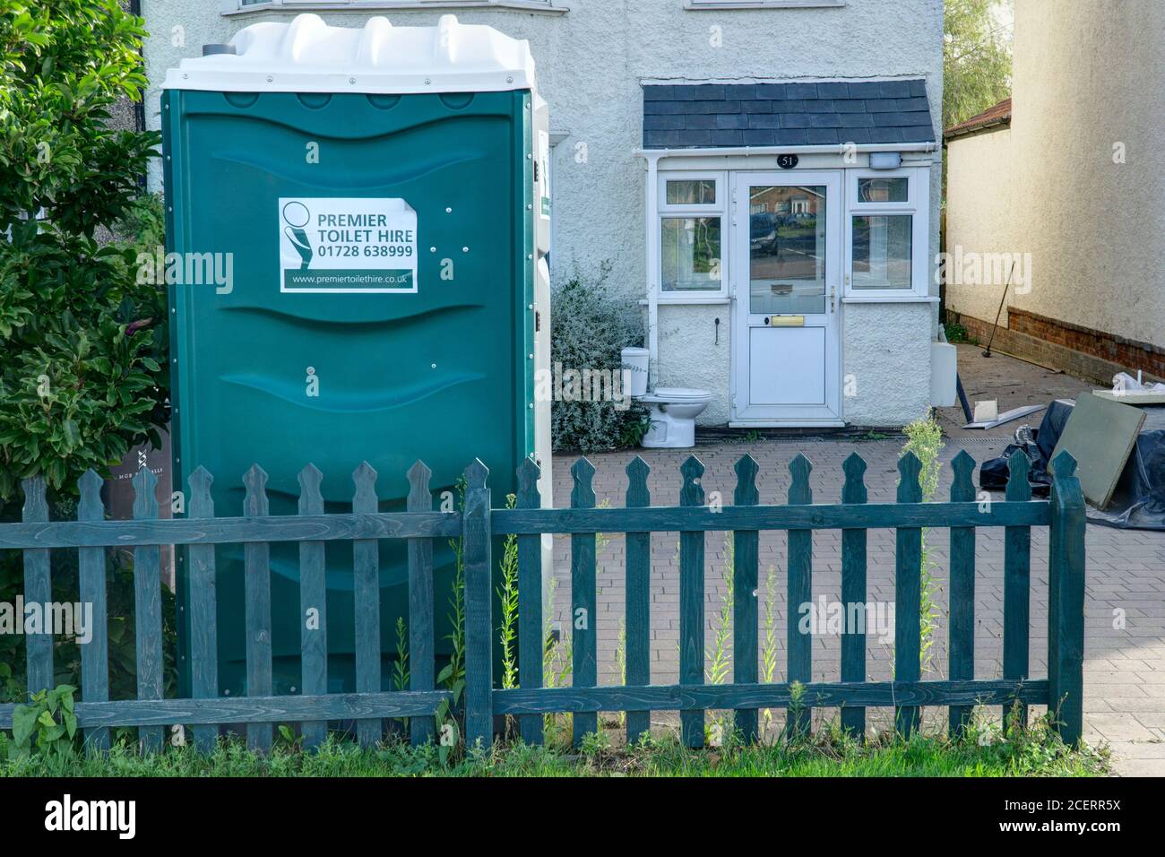loo and toilet outside home green picket fence Stock Photo - Alamy