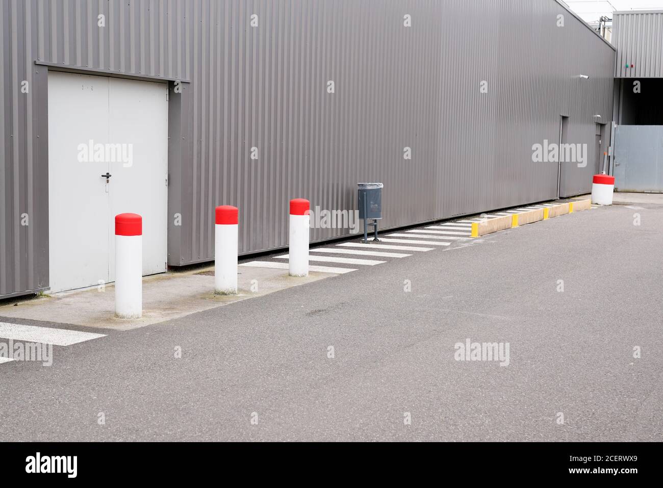 white door emergency exit from a grey warehouse Stock Photo - Alamy