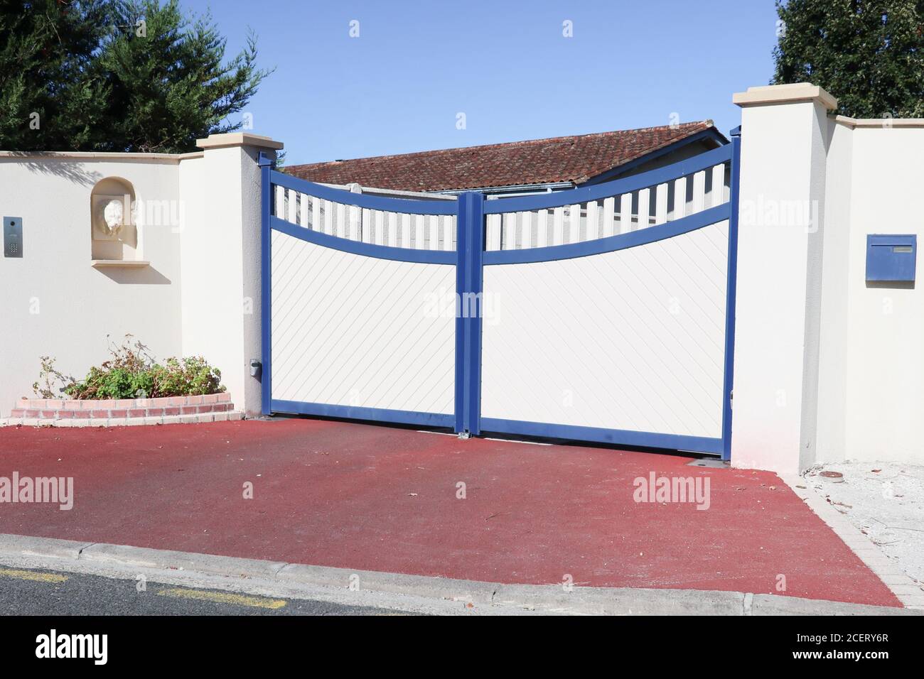 private entry home garden with wood gate and red floor Stock Photo - Alamy