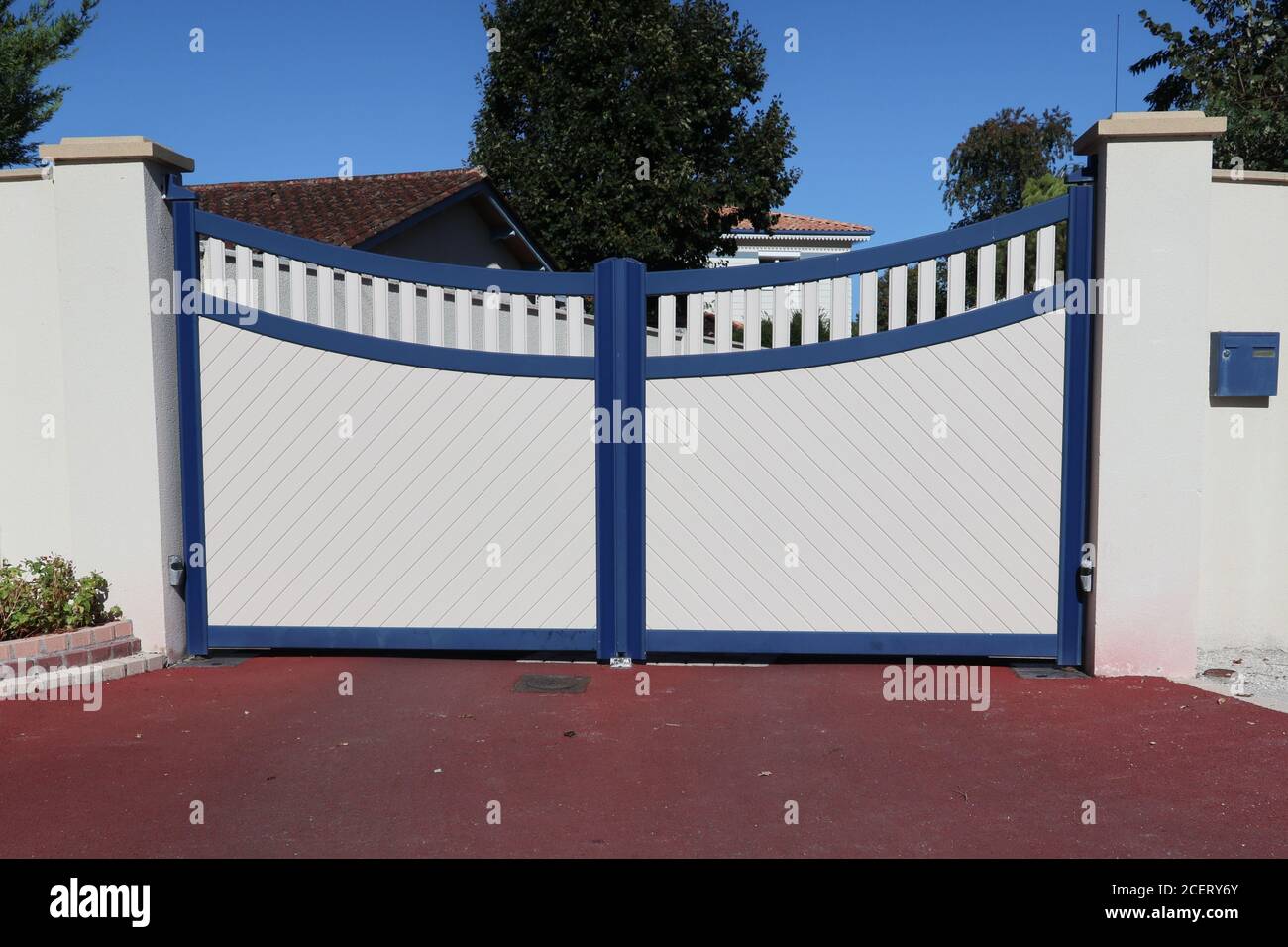 street view large modern wood blue and white gate house Stock Photo - Alamy