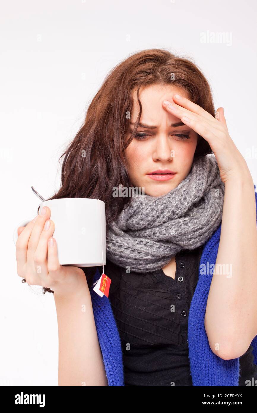 A beautiful young woman, lady, girl, cold, runny nose, headache, cup of ...