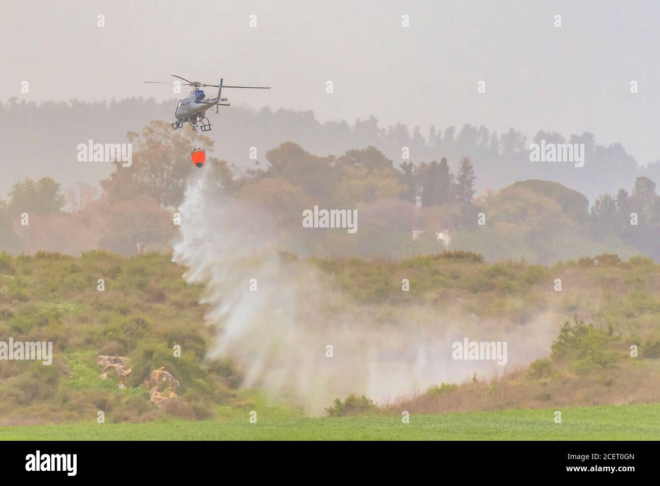 A police helicopter is used during a fire drill to airlift water to the ...