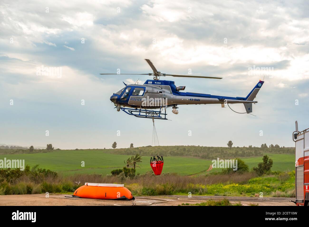 A police helicopter is used during a fire drill to airlift water to the ...