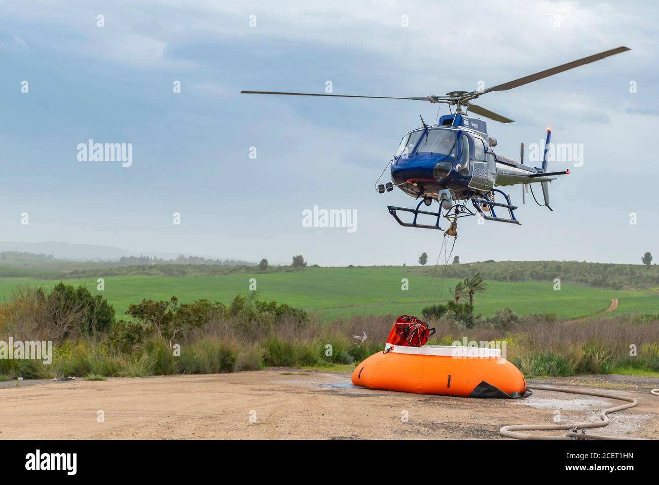 A police helicopter is used during a fire drill to airlift water to the ...