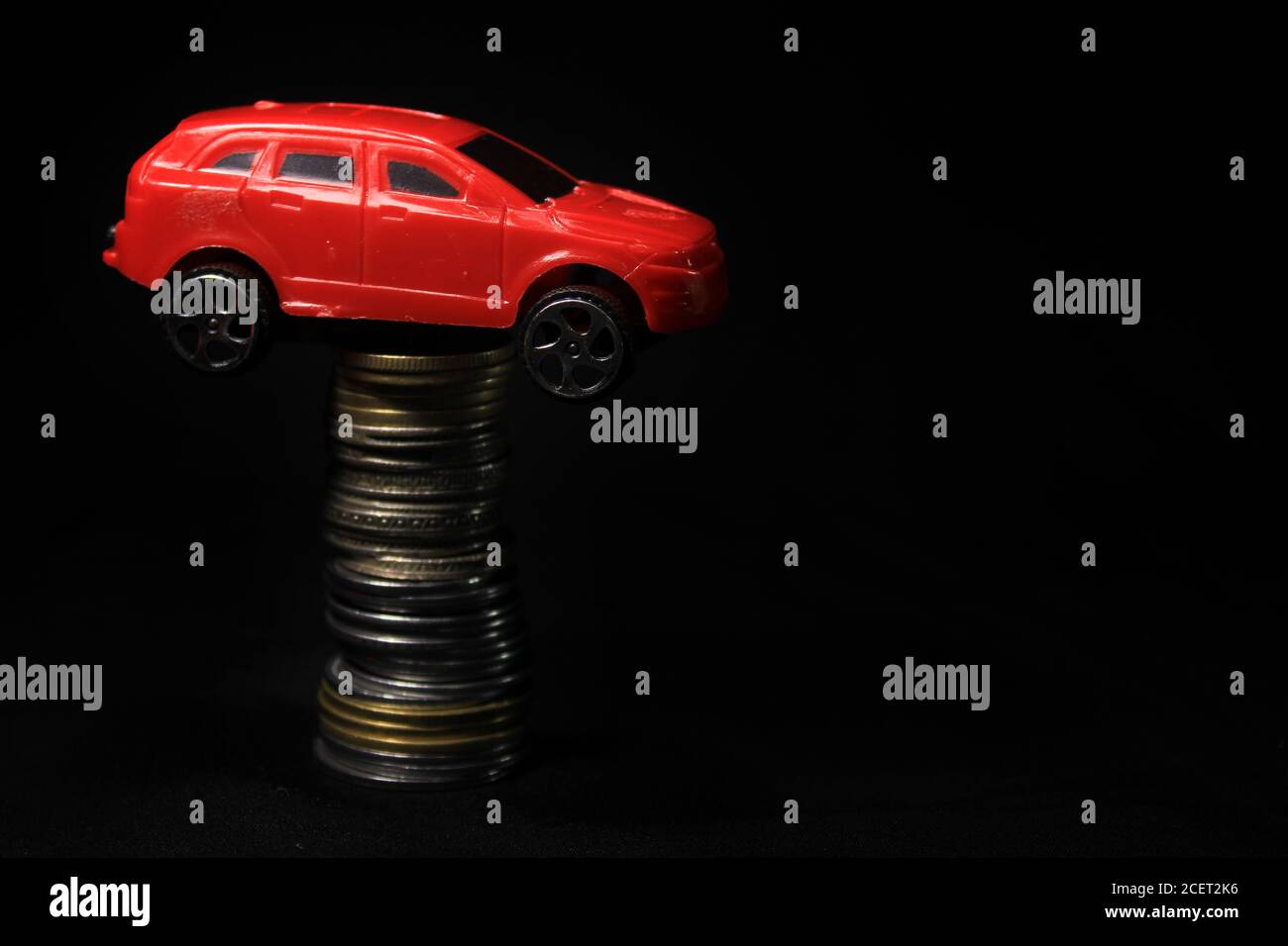 Saving money for a car. Banking, fast. Toy car and coins on black ...