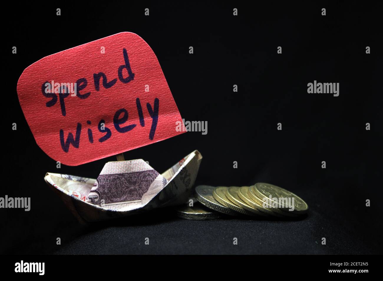 Concept shot giving message to spend money wisely. Money habits concept ...