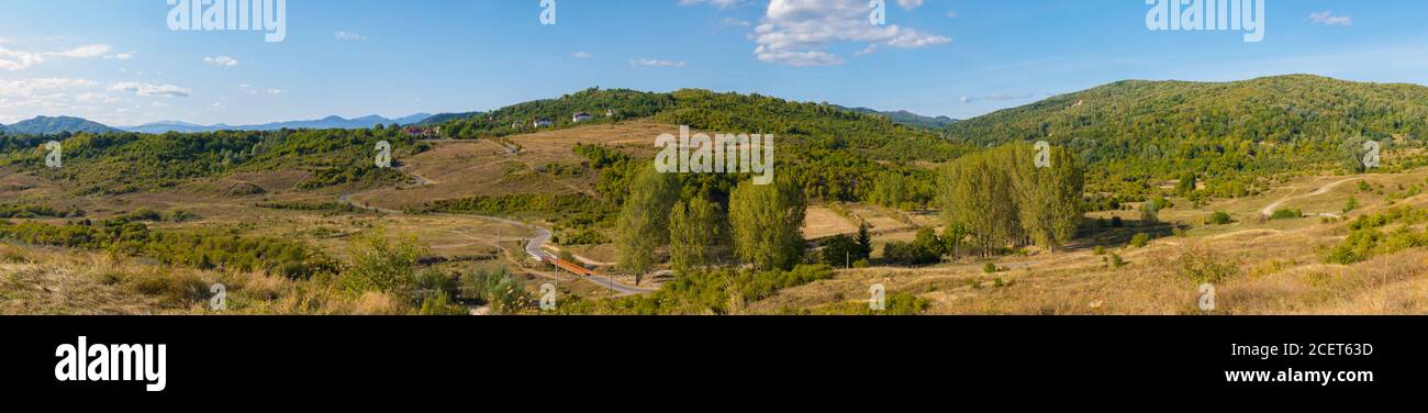 Big panoramic view of hills with green forest. Sub mountain rural ...