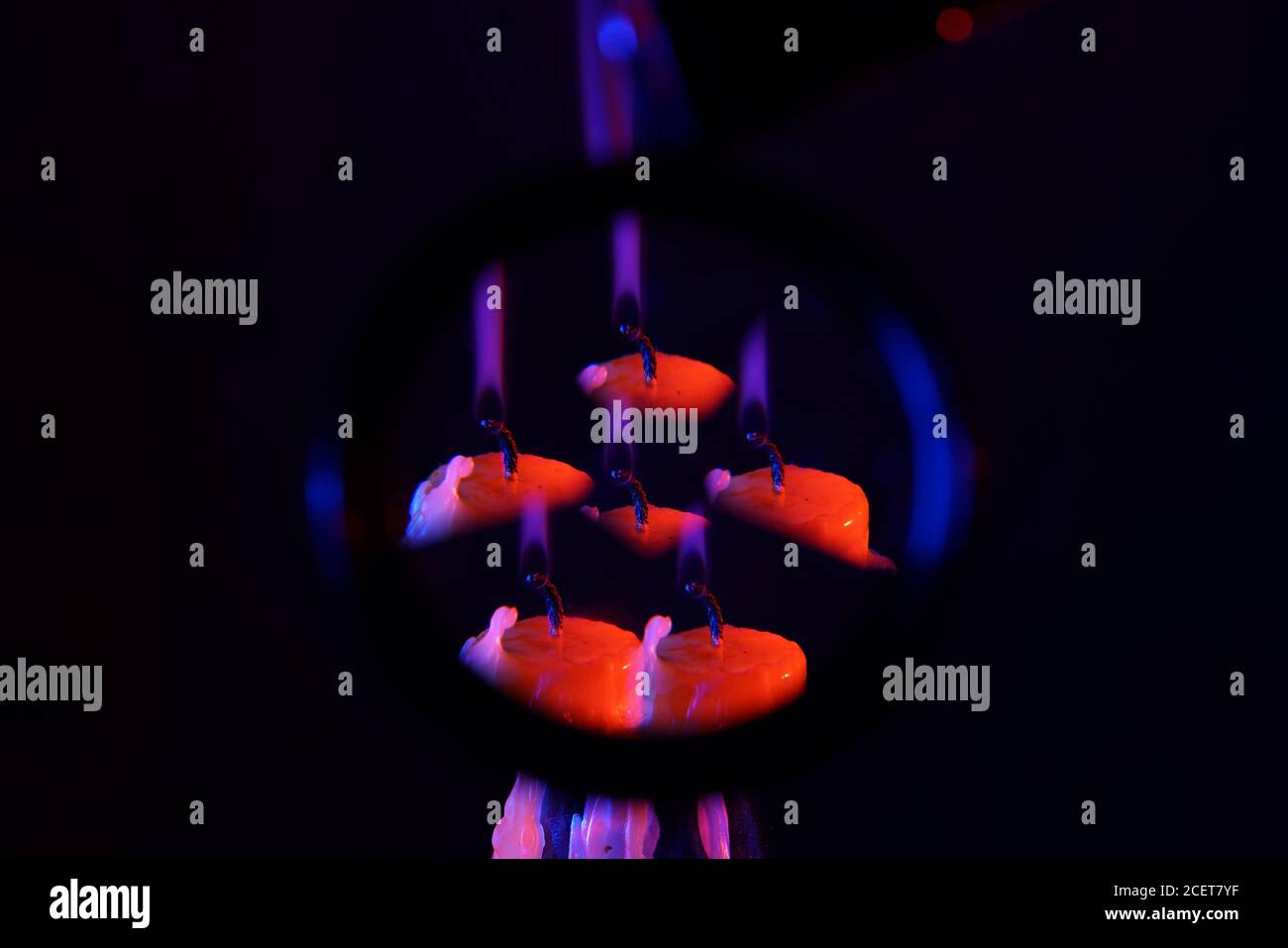 Candle through a magnifying glass Stock Photo - Alamy