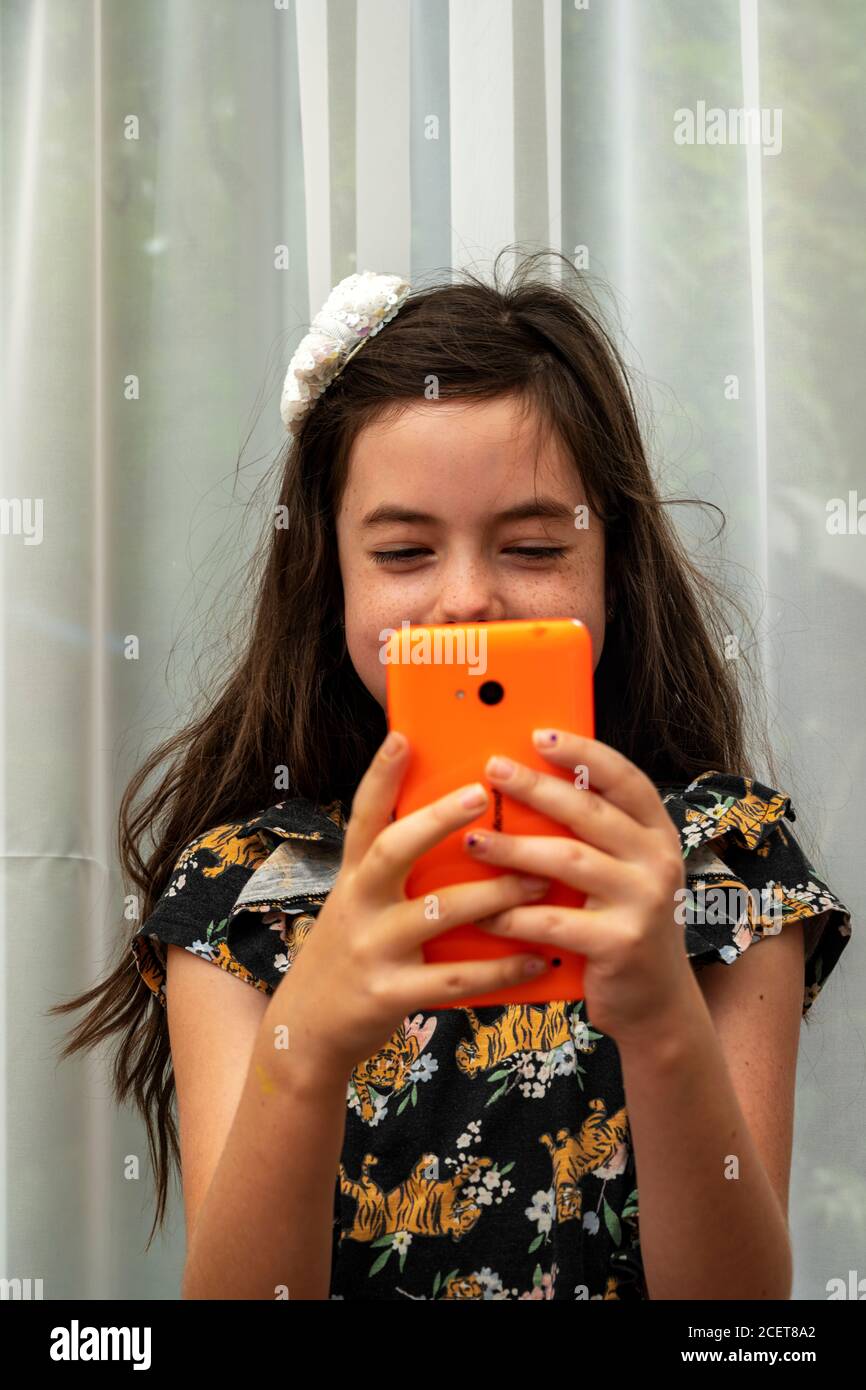 Young girl using a mobile phone Stock Photo - Alamy