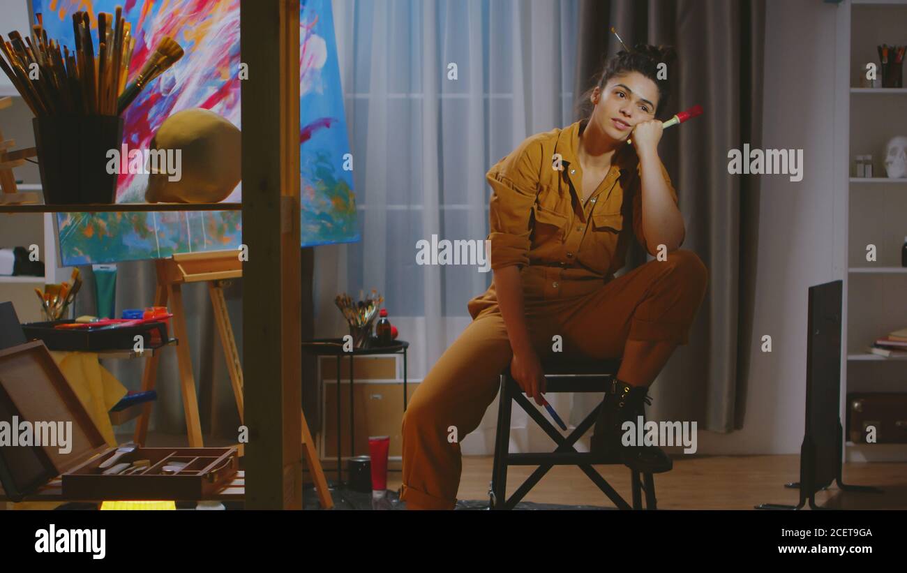 Thoughtful painter in art studio with colorful masterpiece in art ...