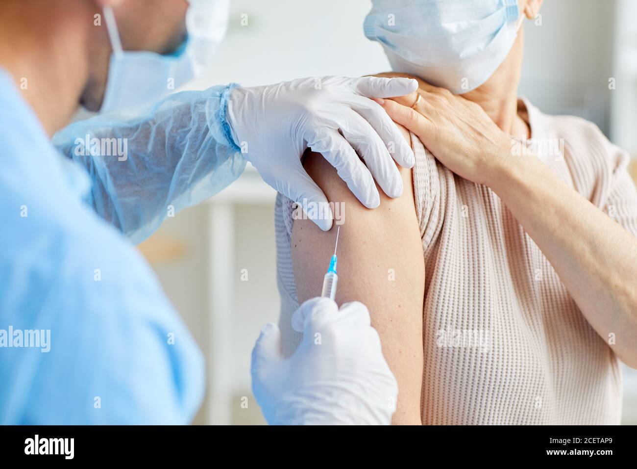Nurse giving male patient injection hi-res stock photography and images ...