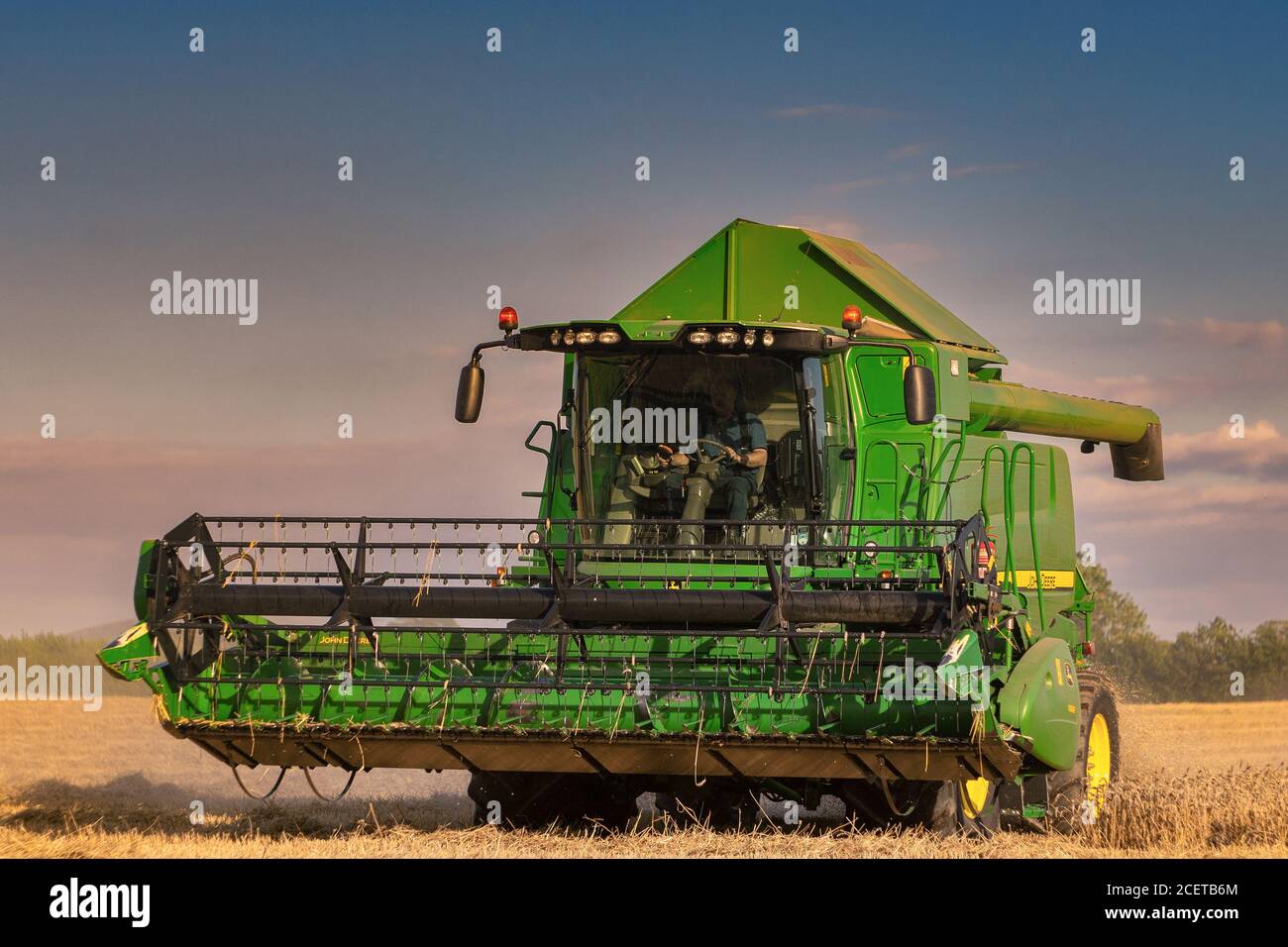 Combined harvester working in the fields Stock Photo - Alamy