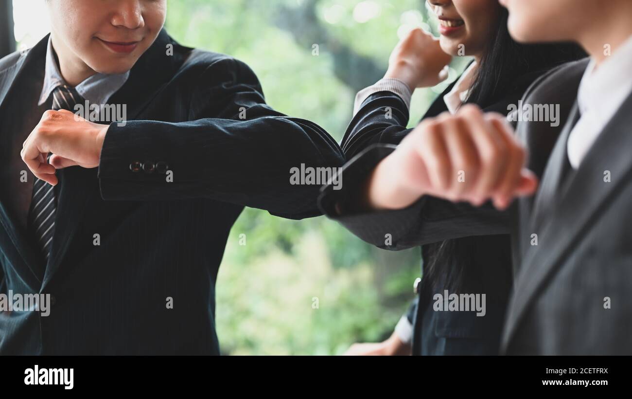 Businesspeople are greeting each other with the elbow. Elbow bumps ...