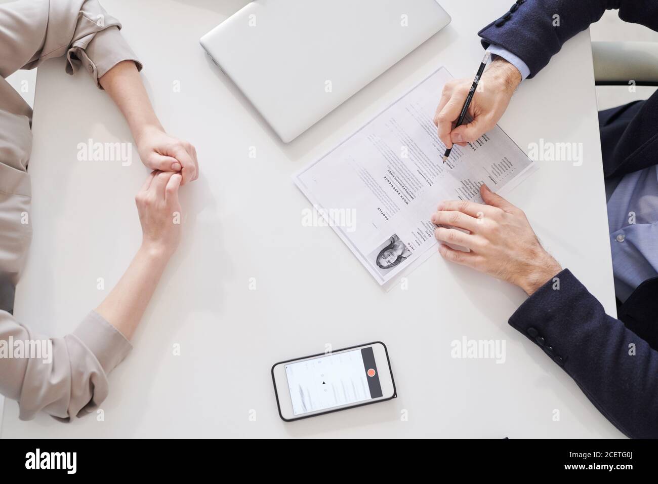 Directly frome above shot of unrecognizable woman sitting in front of ...