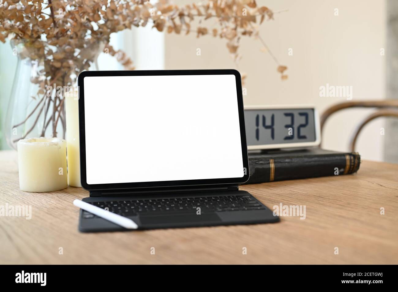 Computer tablet with a white blank screen is putting on a wooden table ...