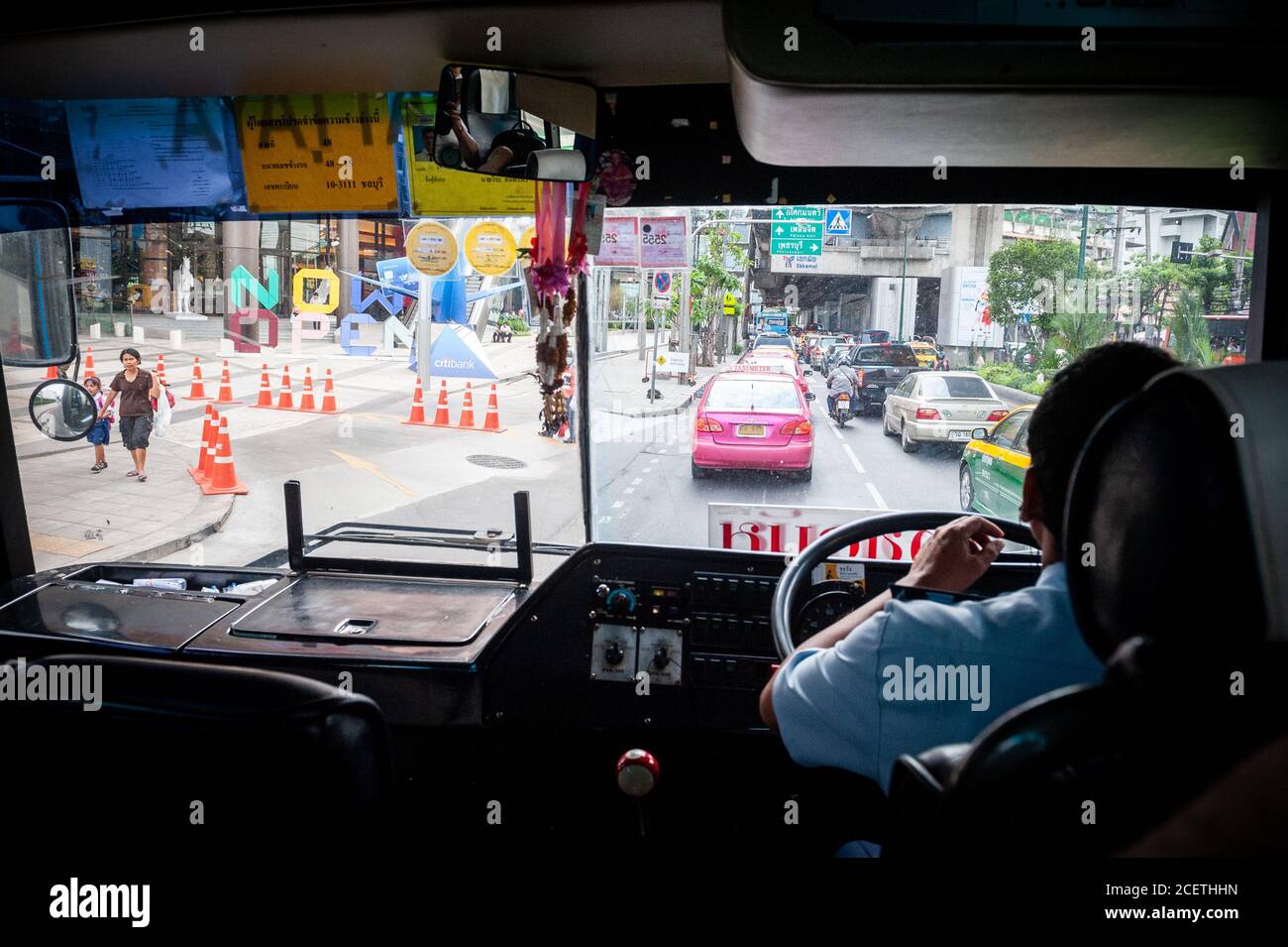 A shot looking through the front window of a typical Thai public bus ...