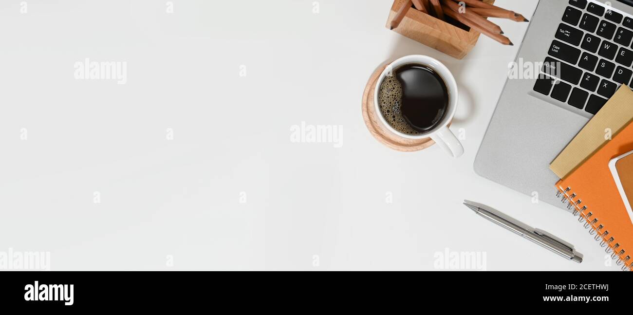 Simple office desk with laptop, coffee, notebook and pencil on white ...