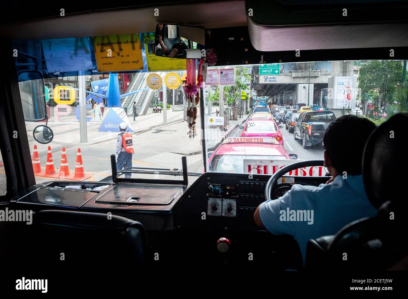 A shot looking through the front window of a typical Thai public bus ...