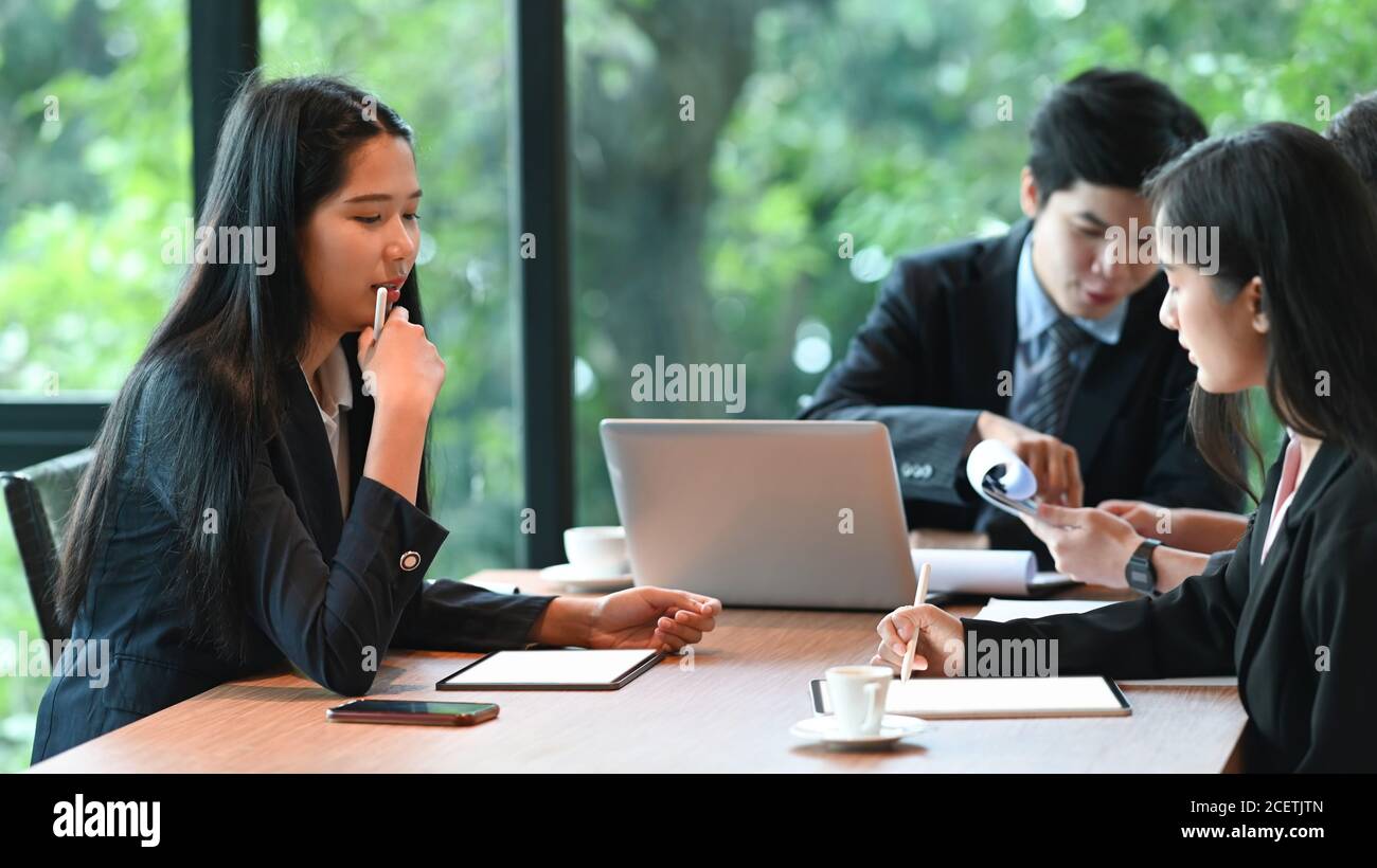 Businesspeople are working together in a comfortable conference room ...