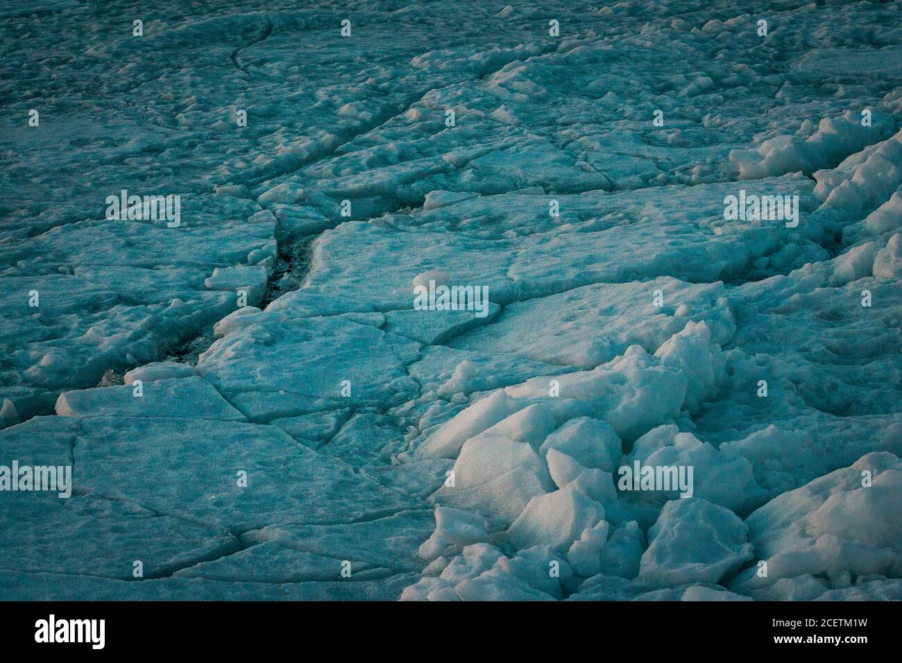 Frozen Ice sheets breaking apart in Petoskey Michigan Stock Photo - Alamy