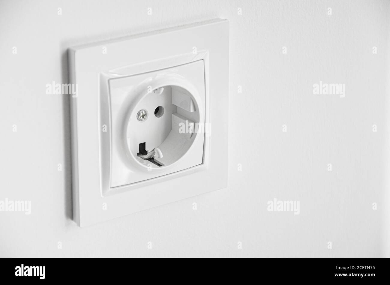 The white plastic socket is mounted in a white wall Stock Photo - Alamy