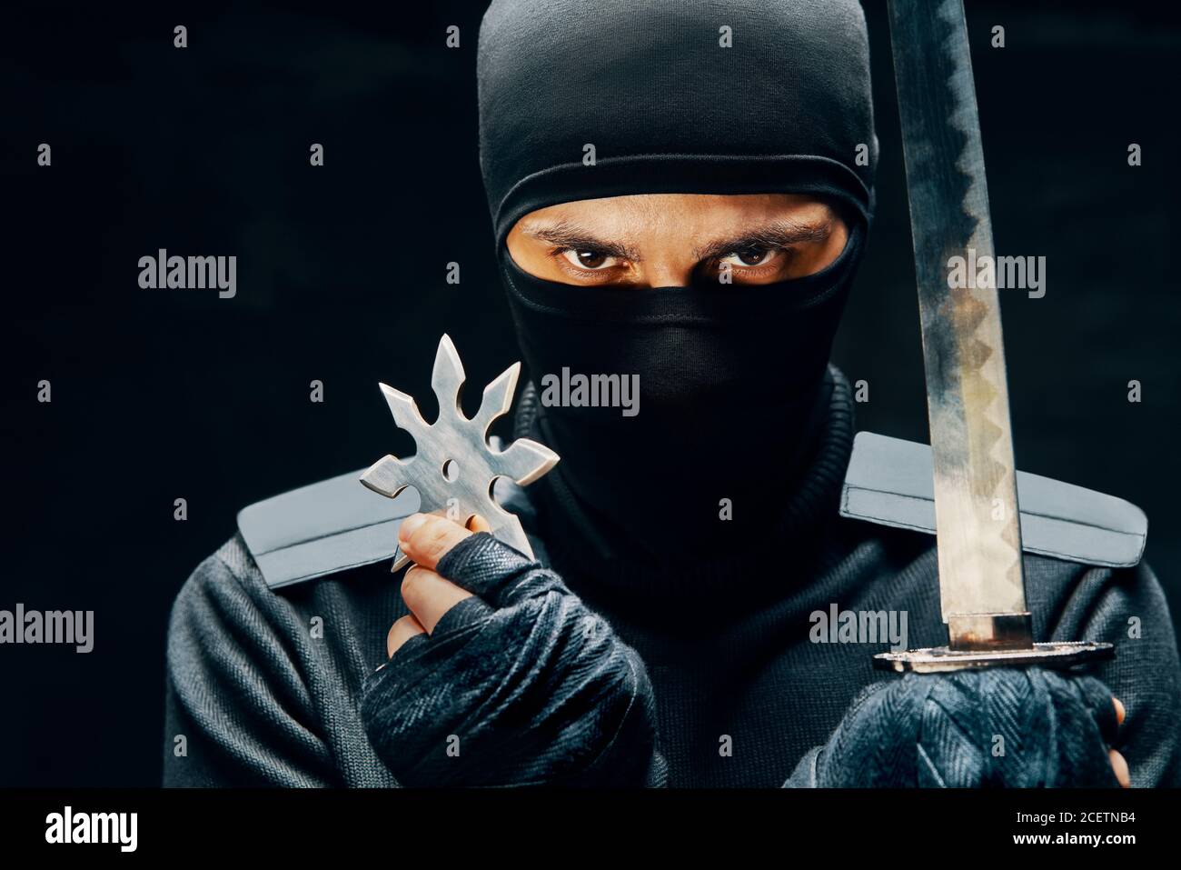 Ninja samurai warrior fighter with a sword and shuriken over black ...