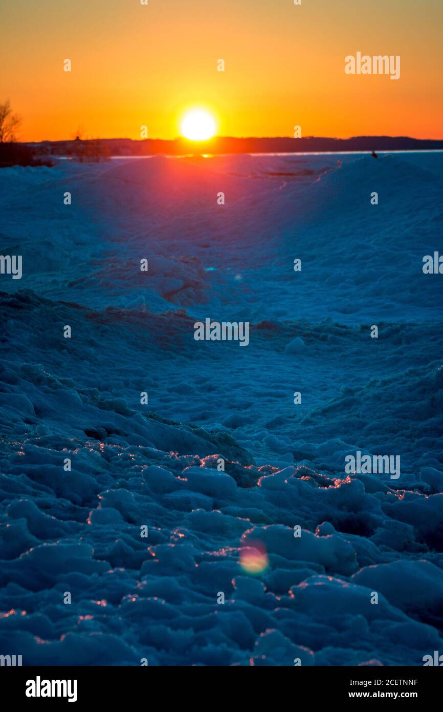 Sunset over a frozen beach in Petoskey Michigan Stock Photo - Alamy