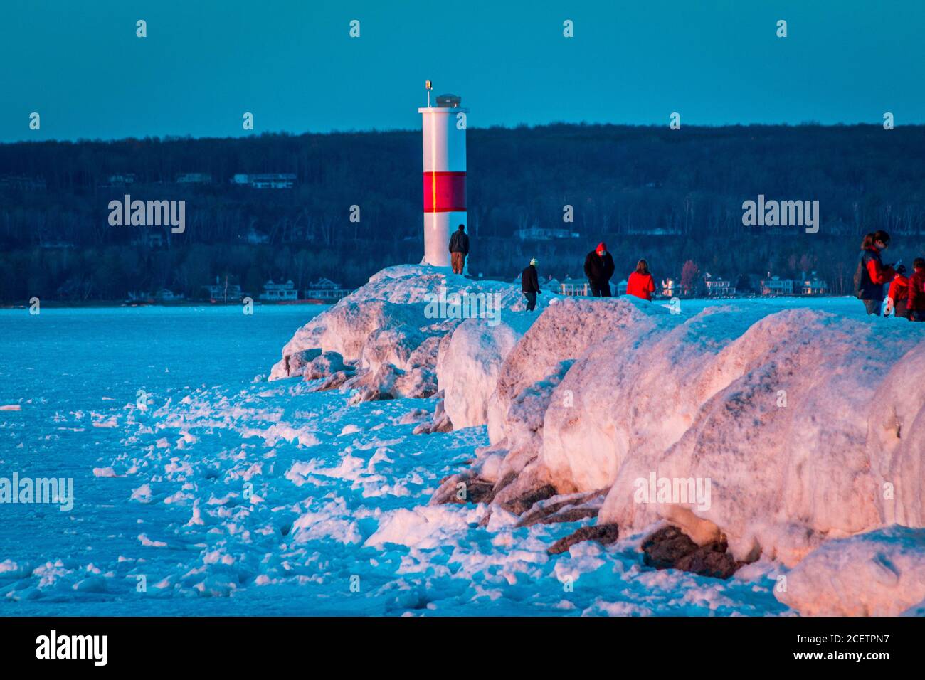 Tourists visiting a frozen lighthouse in Petoskey Michigan Stock Photo ...