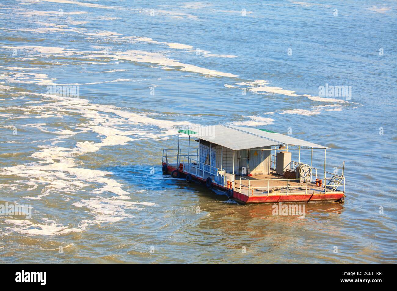 Small passenger ferry on the flowing water Stock Photo - Alamy