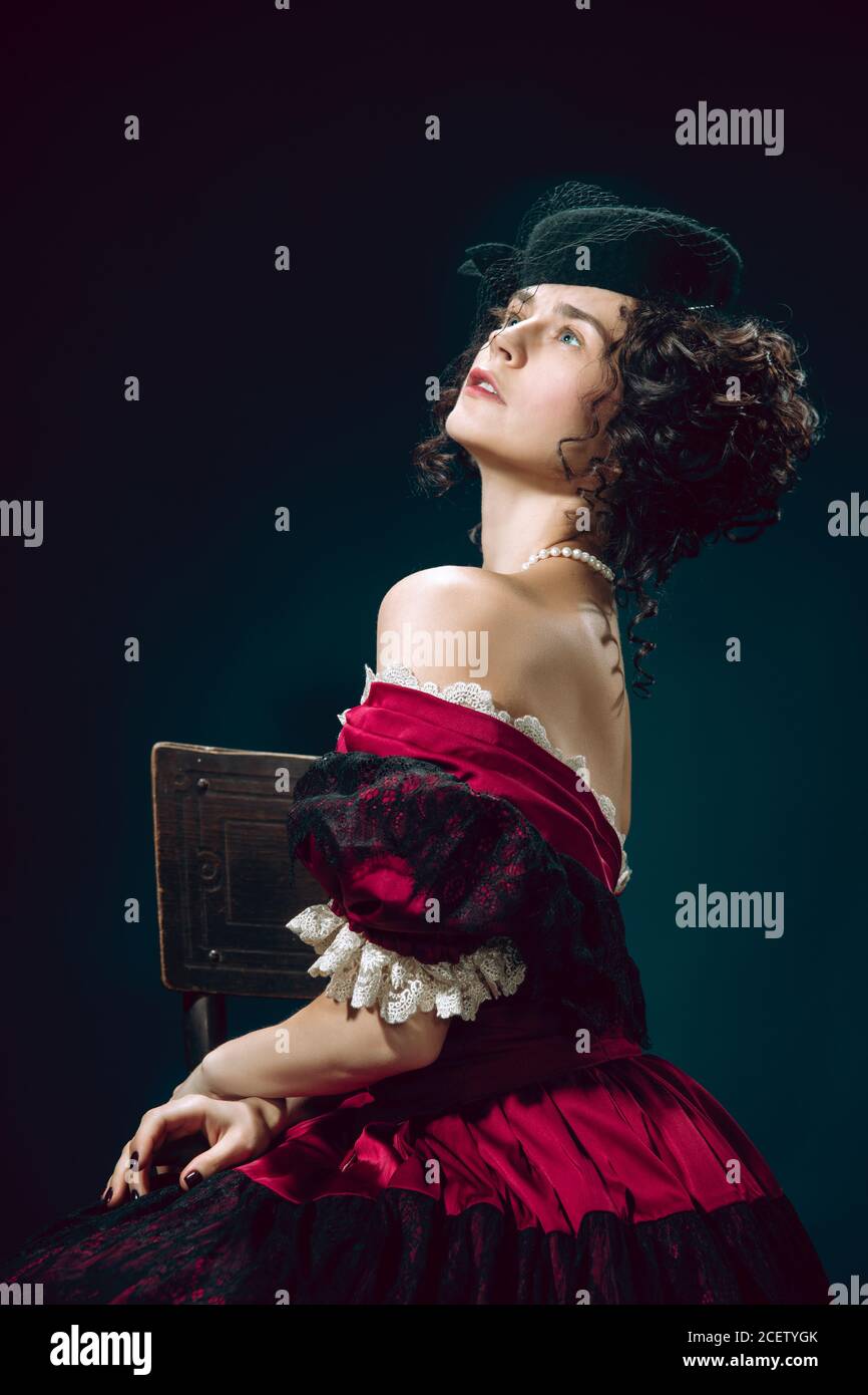 Love tragic. Young woman as Anna Karenina isolated on dark blue ...