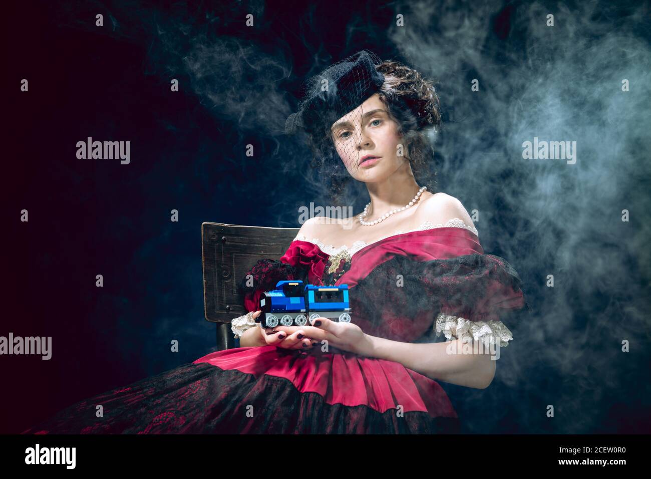 Train model. Young woman as Anna Karenina isolated on dark blue ...