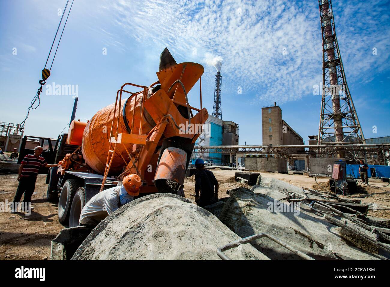 Old phosphate fertilizer plant in modernization. Mobile crane, workers ...