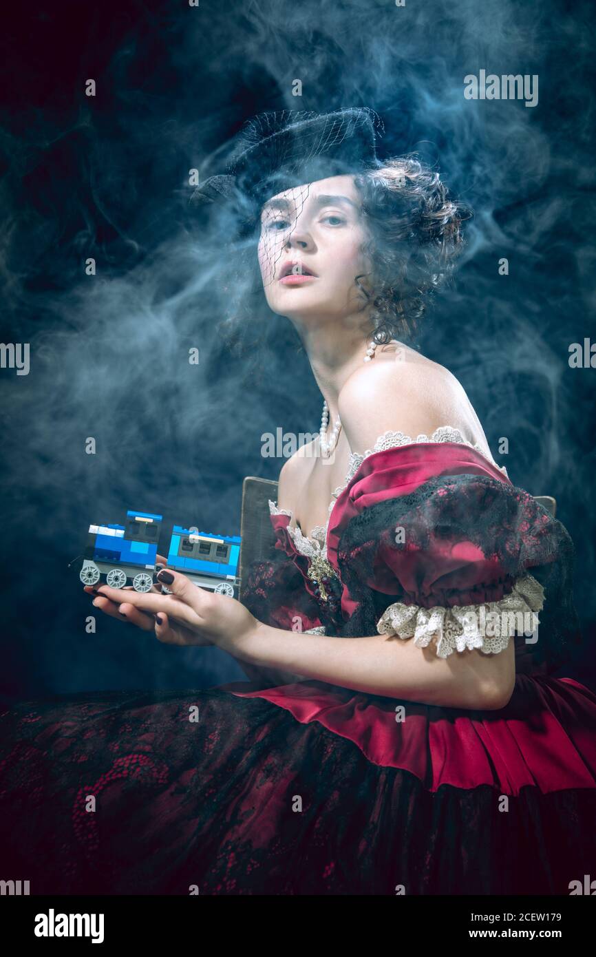 Train model. Young woman as Anna Karenina isolated on dark blue ...