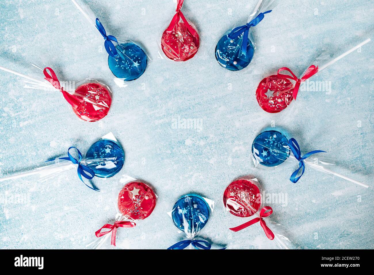 Blue and red lollipops forming a circle on blue background ...