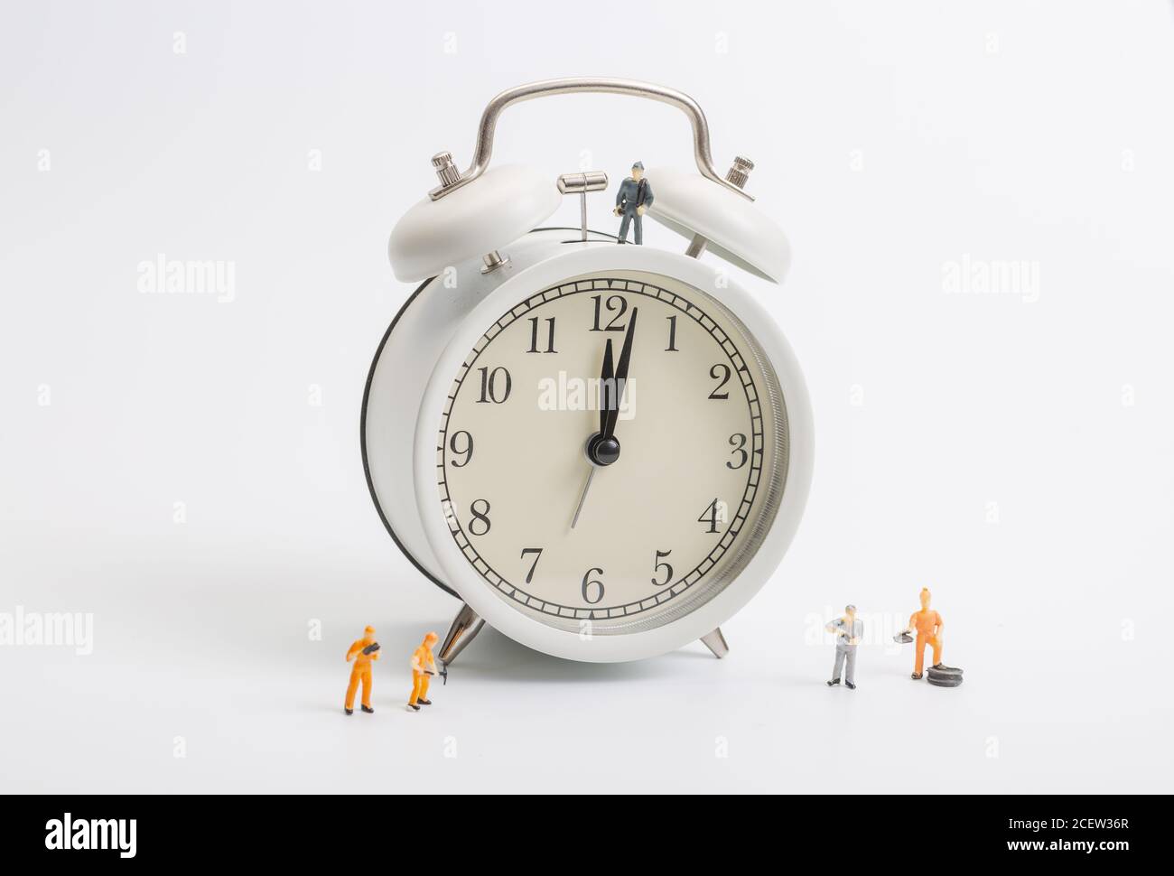 Alarm clock worker on white background Stock Photo - Alamy