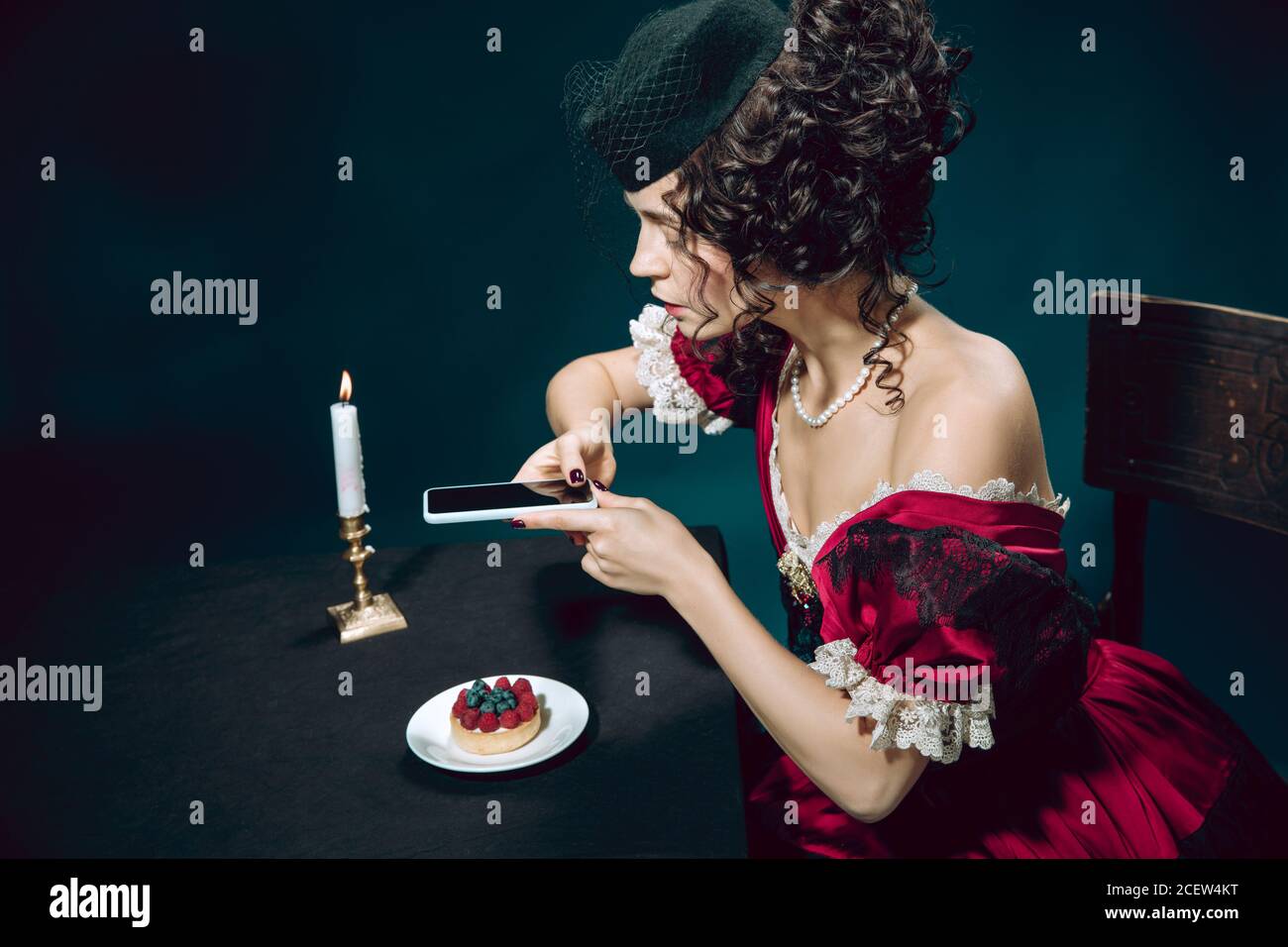 Taking photo for blog. Young woman as Anna Karenina isolated on dark ...