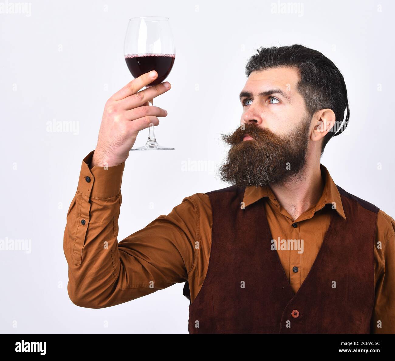 Man with beard and mustache holds alcohol on white background. Service ...