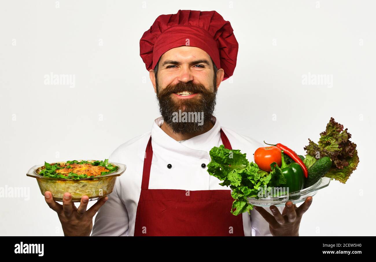 Cooking and vegetarian diet concept. Cook with proud smile in burgundy ...