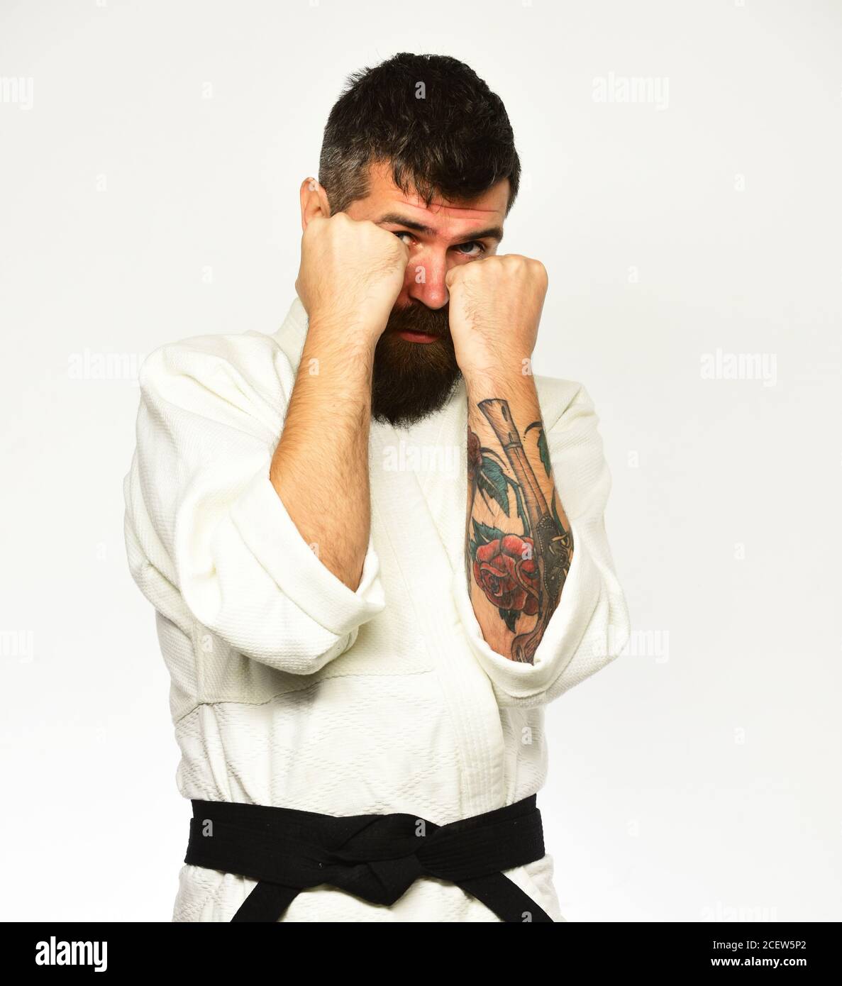 Man with beard in white kimono on white background. Jiu Jitsu master ...