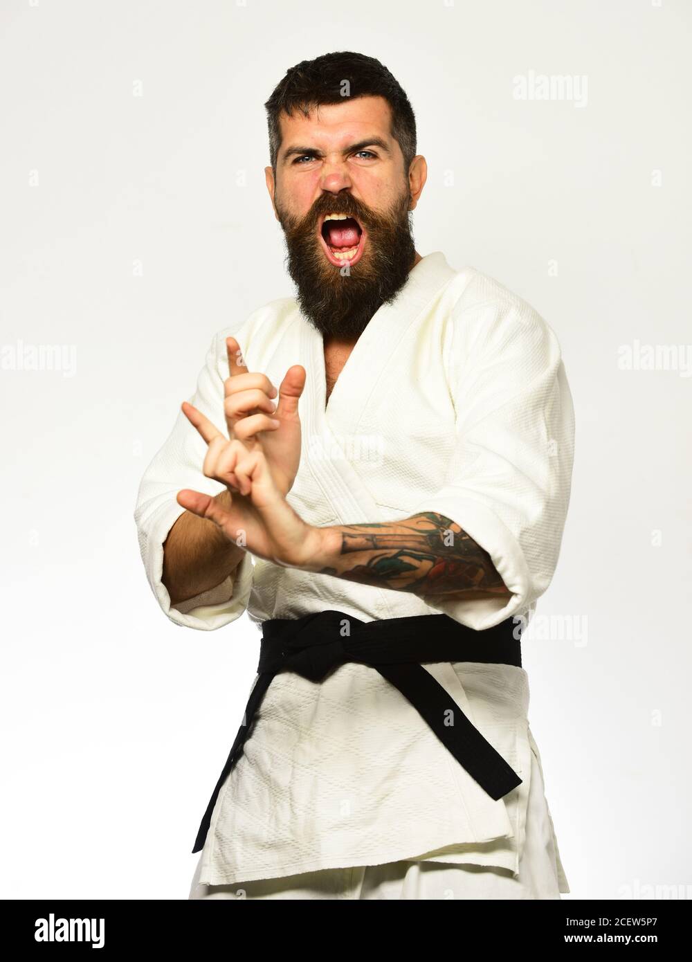 Man with beard in white kimono on white background. Karate man with mad ...