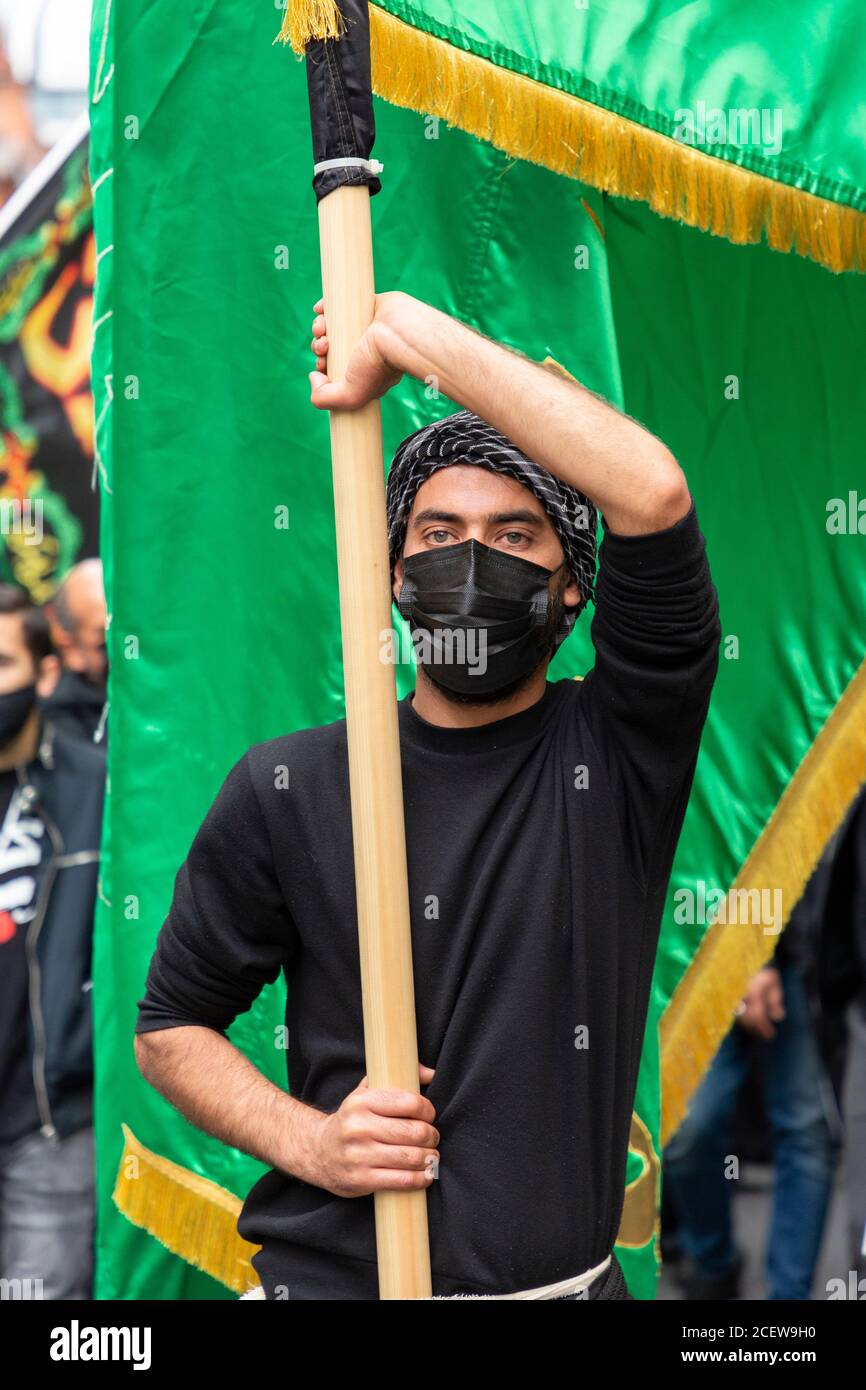 Portrait of flag-bearer during Ashura Day event for Shia Muslims ...