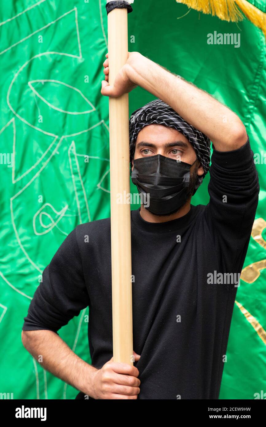 Portrait of flag-bearer during Ashura Day event for Shia Muslims ...