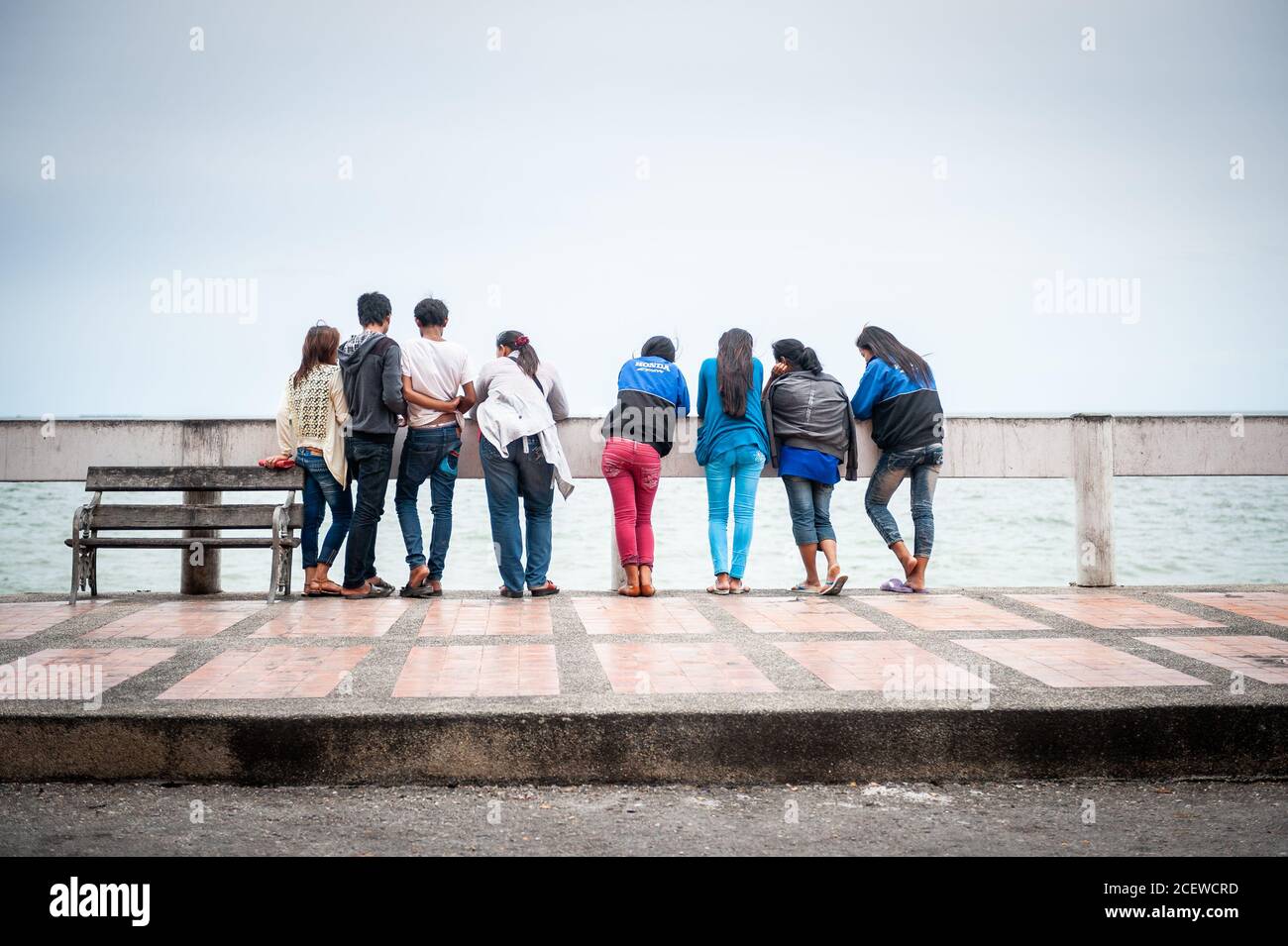 A gang of Thai teenagers hang out at a pier in Bang Saen, near Pattaya ...