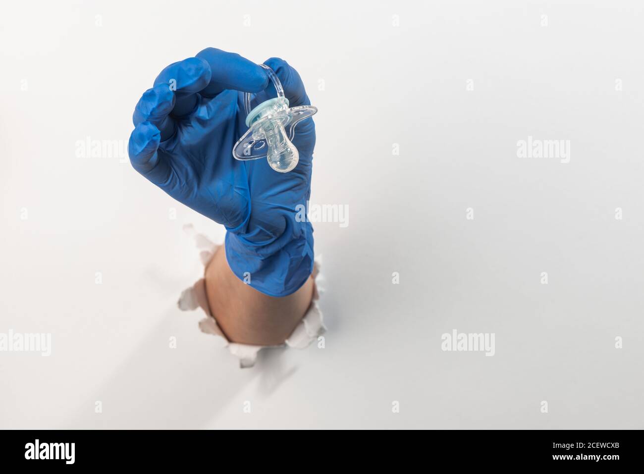 Hand holding baby pacifier hi-res stock photography and images - Alamy