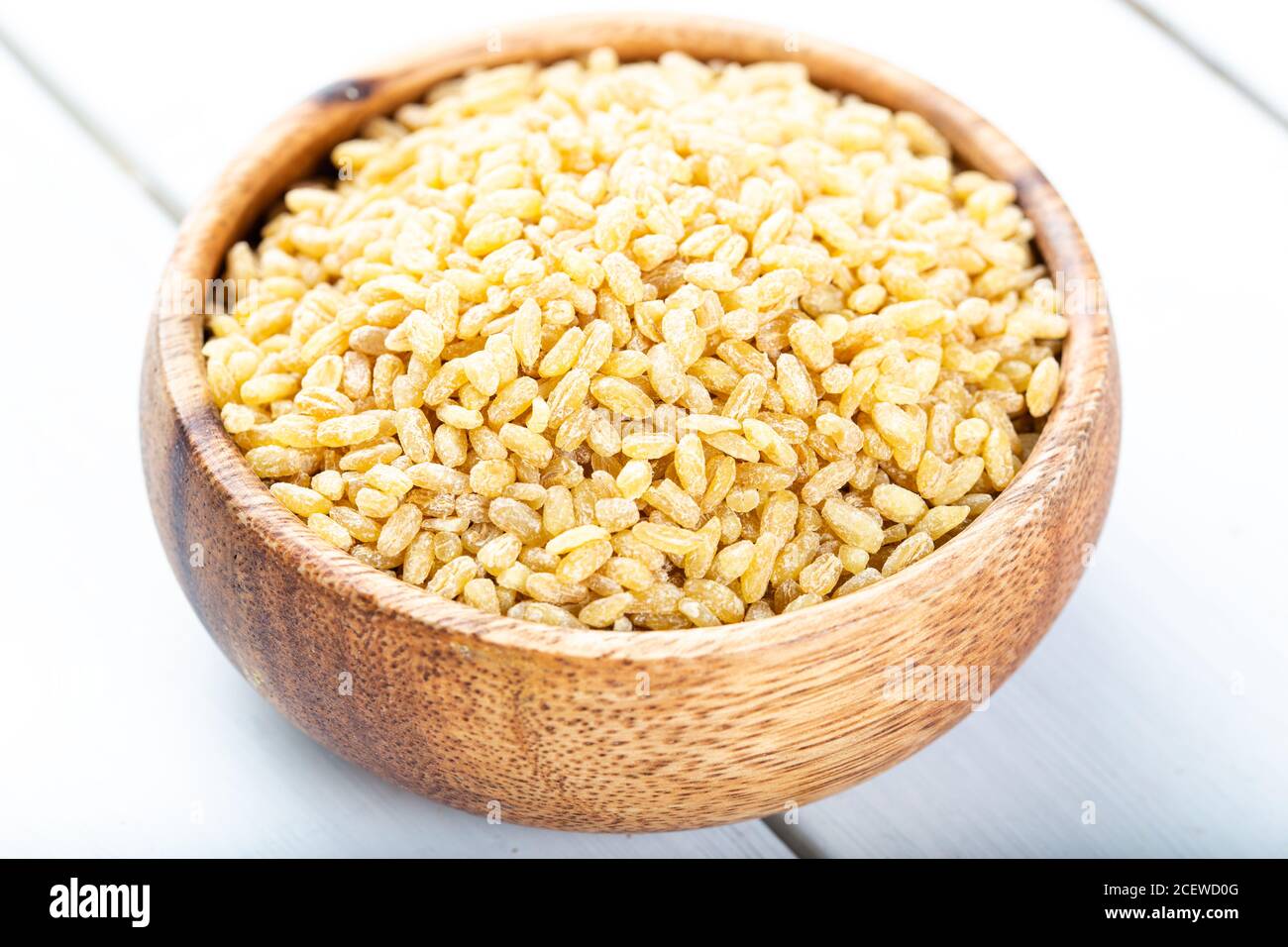 Raw uncooked bulgur wheat grains in a bowl close up Stock Photo - Alamy