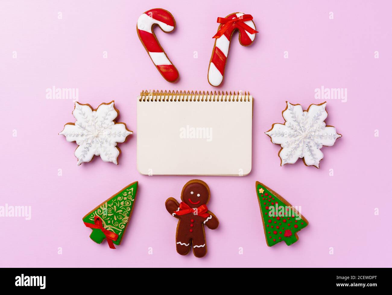 Mock up of holiday greeting card with gingerbread cookies on pink ...