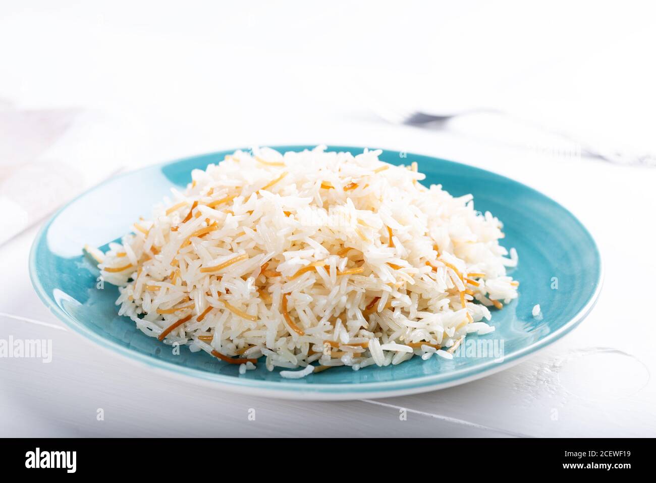 Cooked basmati rice served in a ceramic bowl or plate on white ...