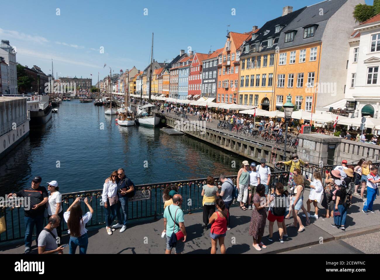 Busy street view of the River Nyhavn Copenhagen with coloured ...