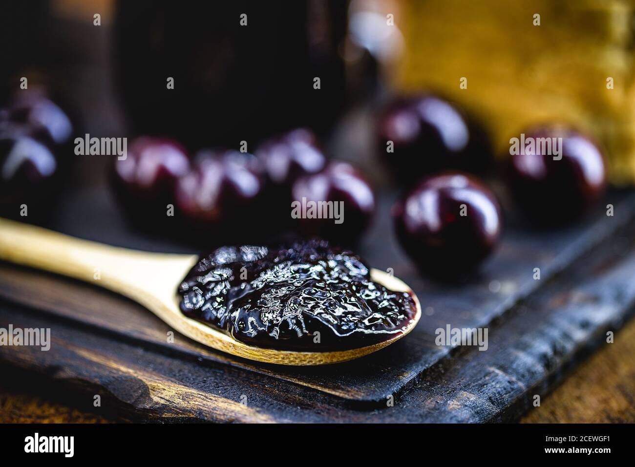 toast with grape jam, on rustic wooden table. Jabuticaba, exotic ...